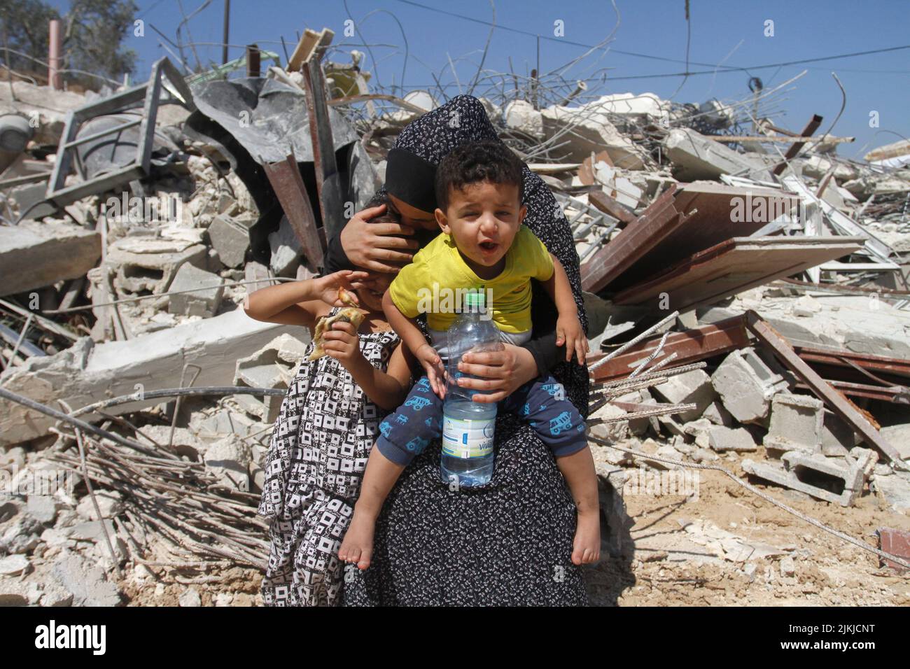 A Palestinian mother and her children seen emotional over the loss of ...