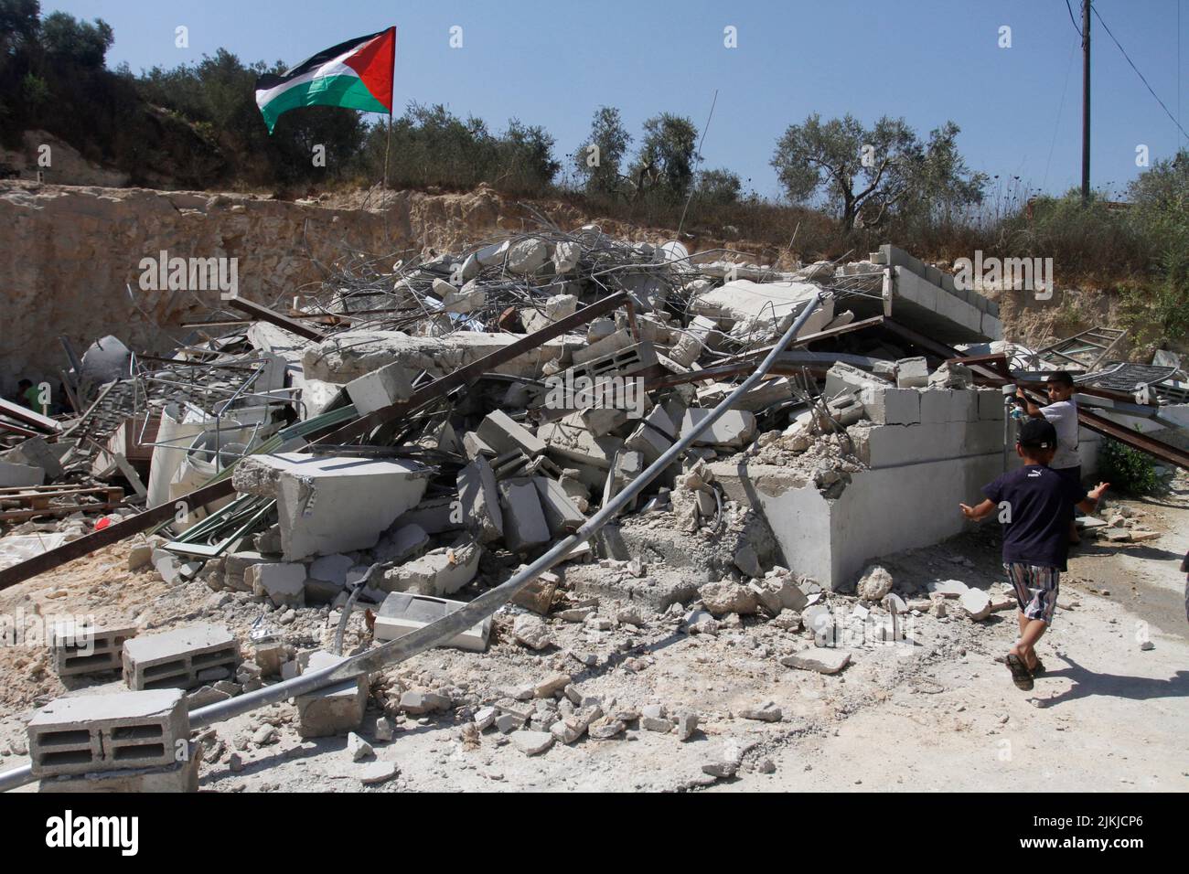 Palestinian children play next to debris of their family house after it ...