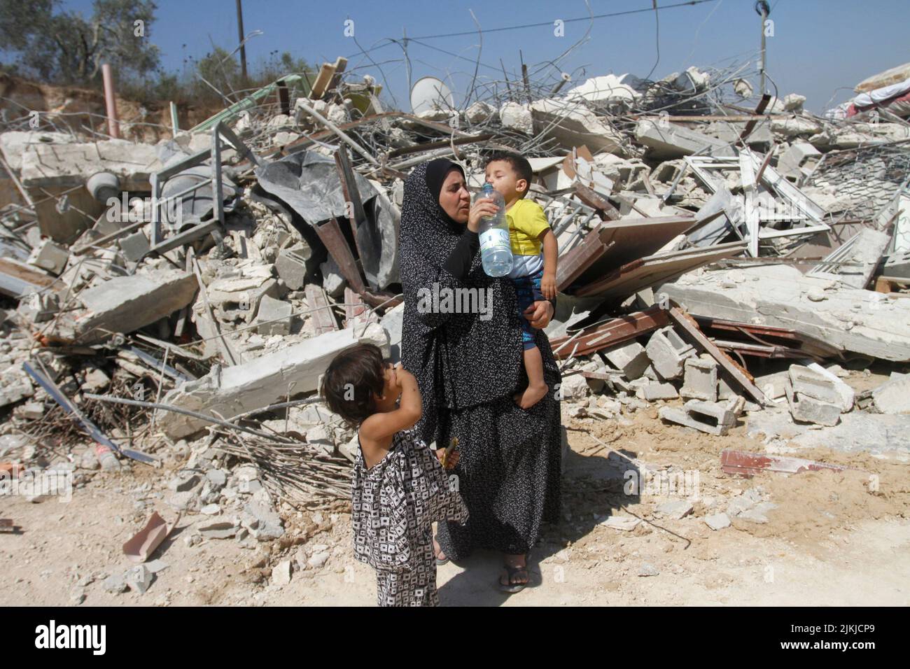 A Palestinian family seen emotional next to the wreckage of their house ...