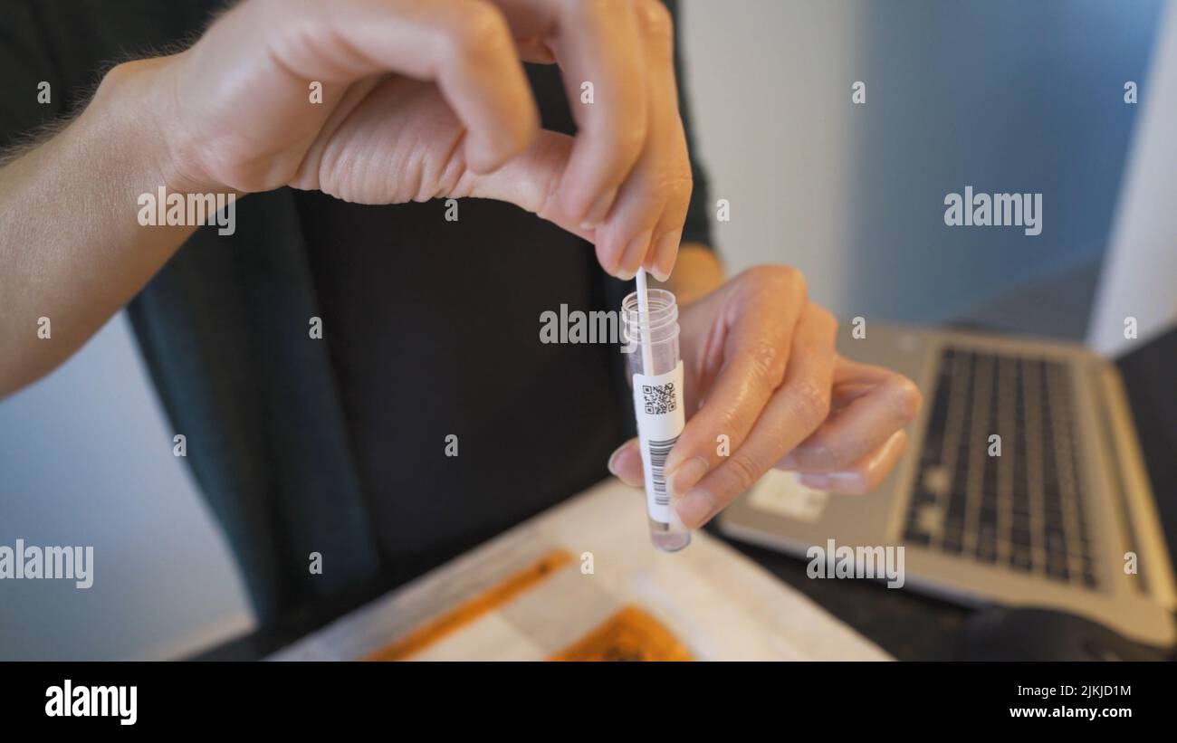 An inserting the PCR covid-19 test swab sample into the container Stock ...