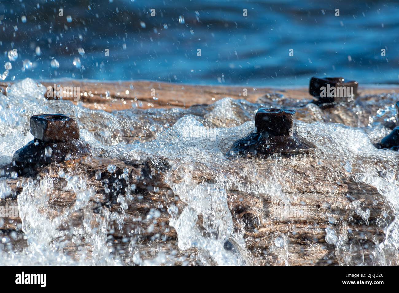 Waves crashing and spraying over a freshwater shipwreck remains with ...