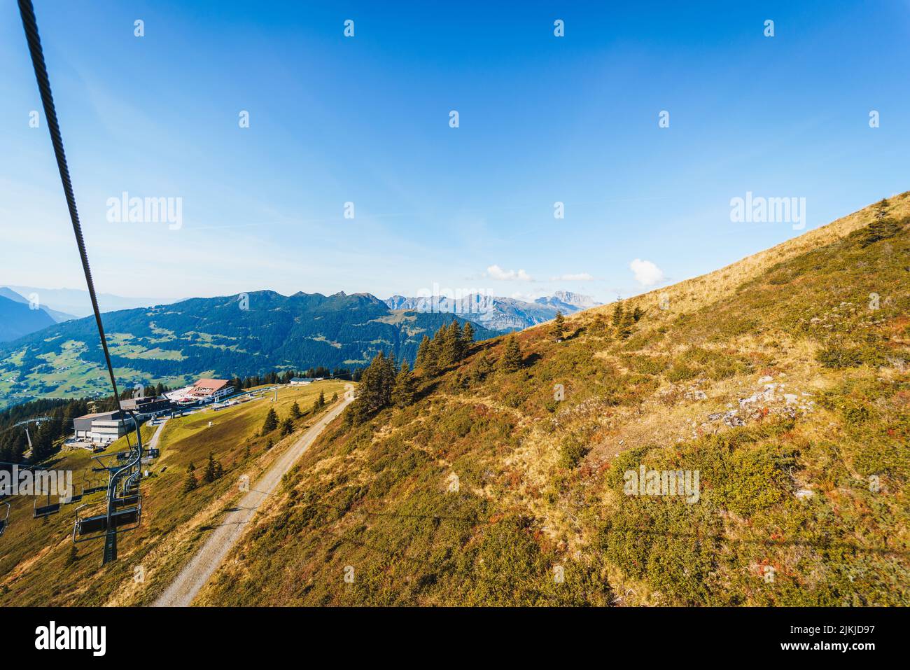 The beautiful view of the chairlift against the background of mountains ...