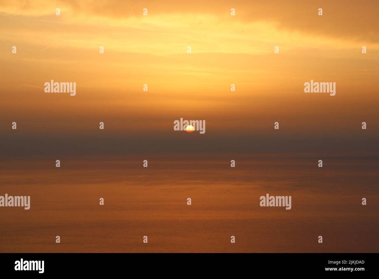 A mesmerizing scenery of a bright yellow sunset on a cloudy weather ...