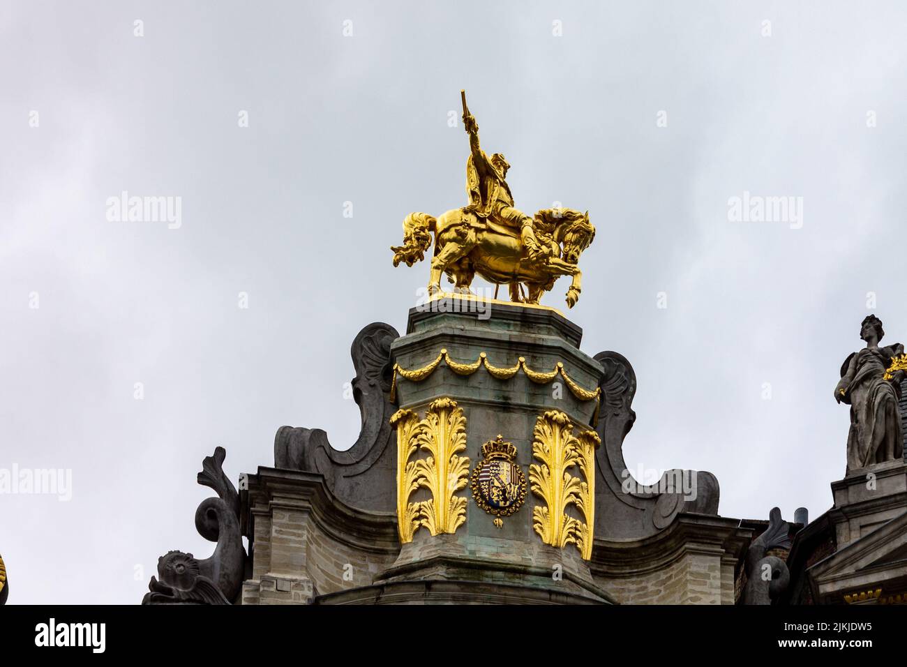 A closeup of a golden sculpture on the roof of Guild historical ...