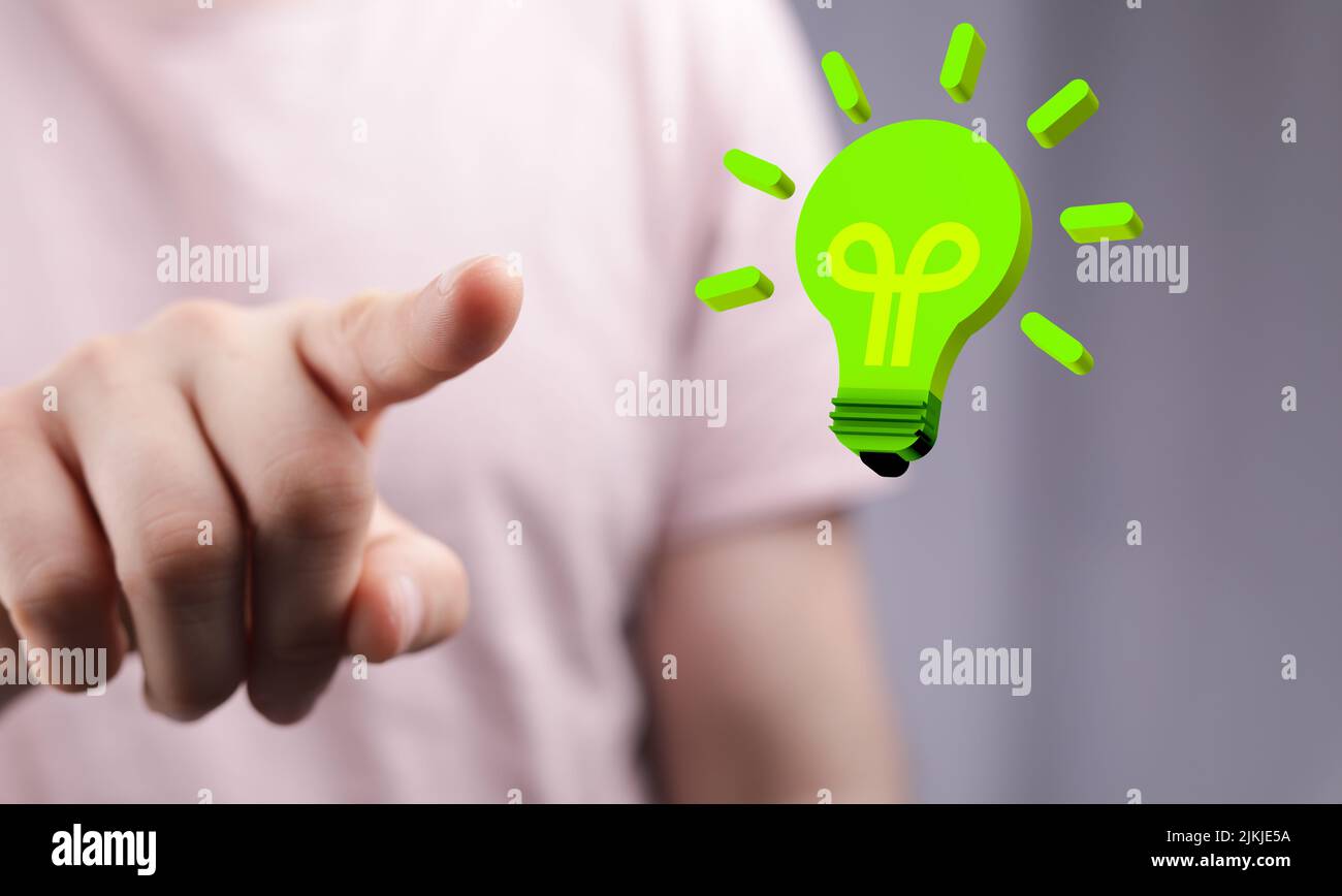 A man tapping on hologram of a green lightbulb. Renewable energy ...