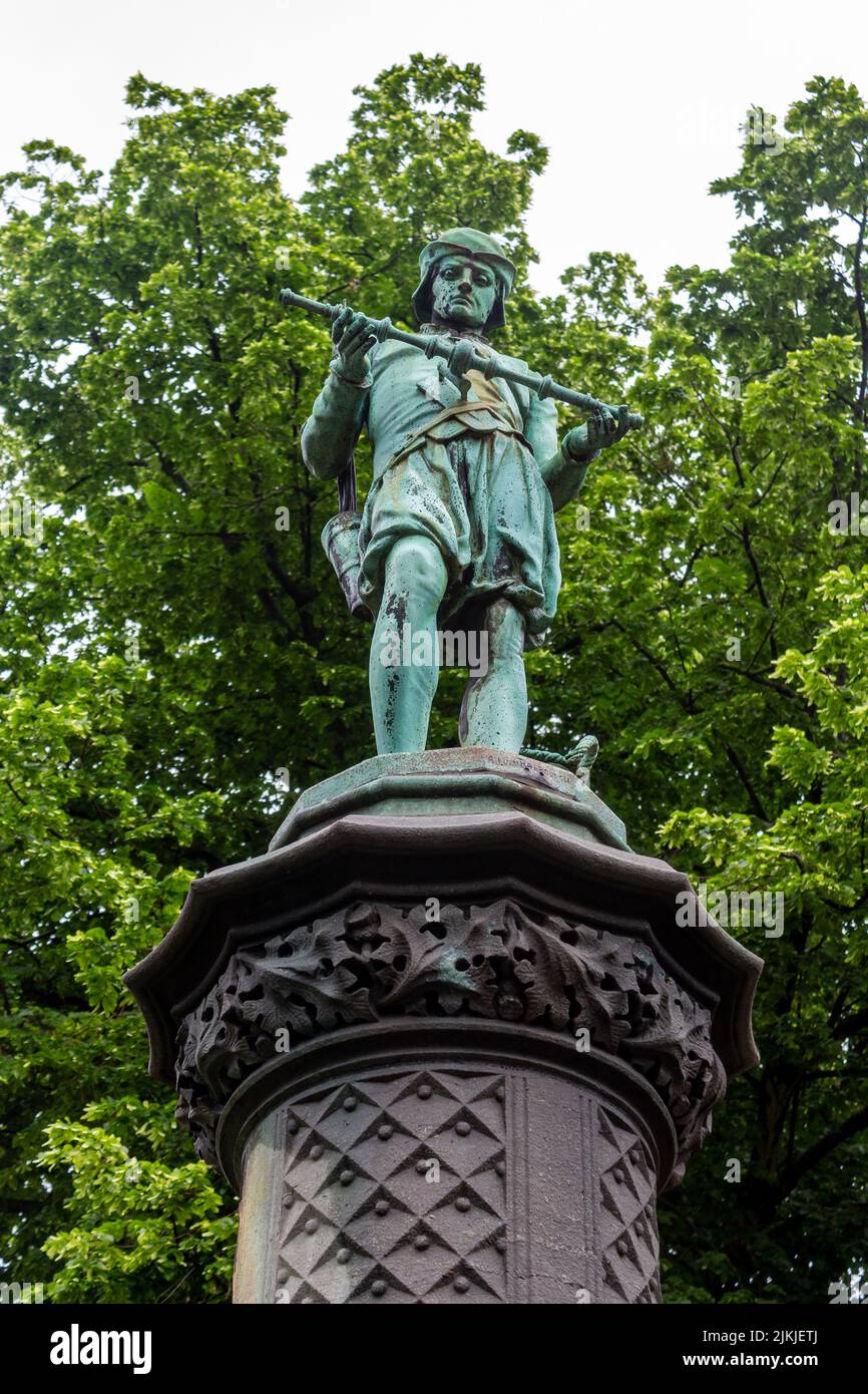 An impressive vertical shot of a blue statue in the Petit Sablon Square ...