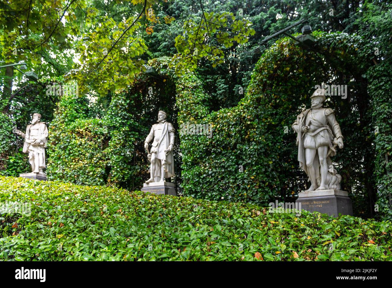 A beautiful shot of 3 marble statues during spring in the Petit Sablon ...