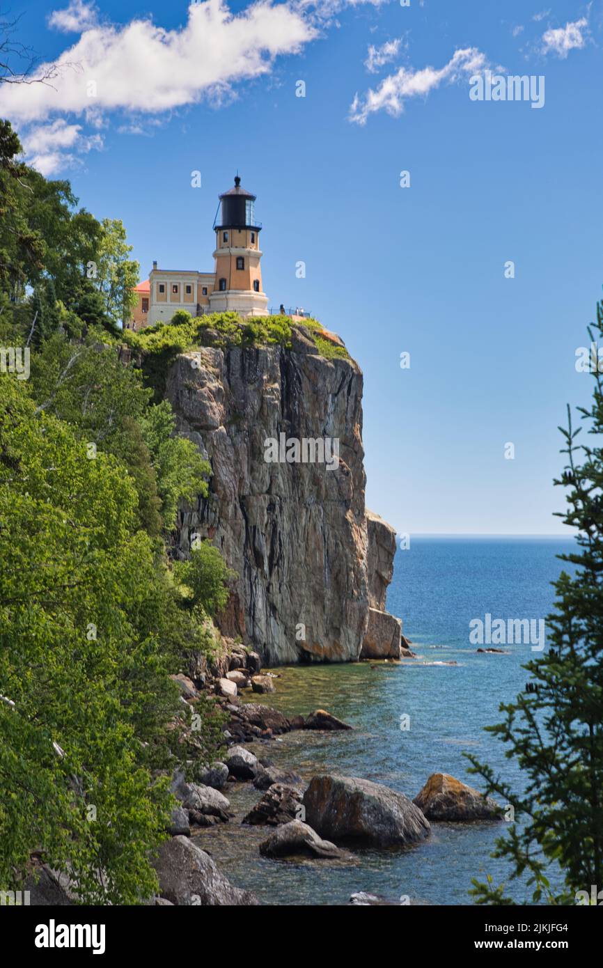 A vertical shot of the Split Rock Lighthouse on the coastline of Lake ...