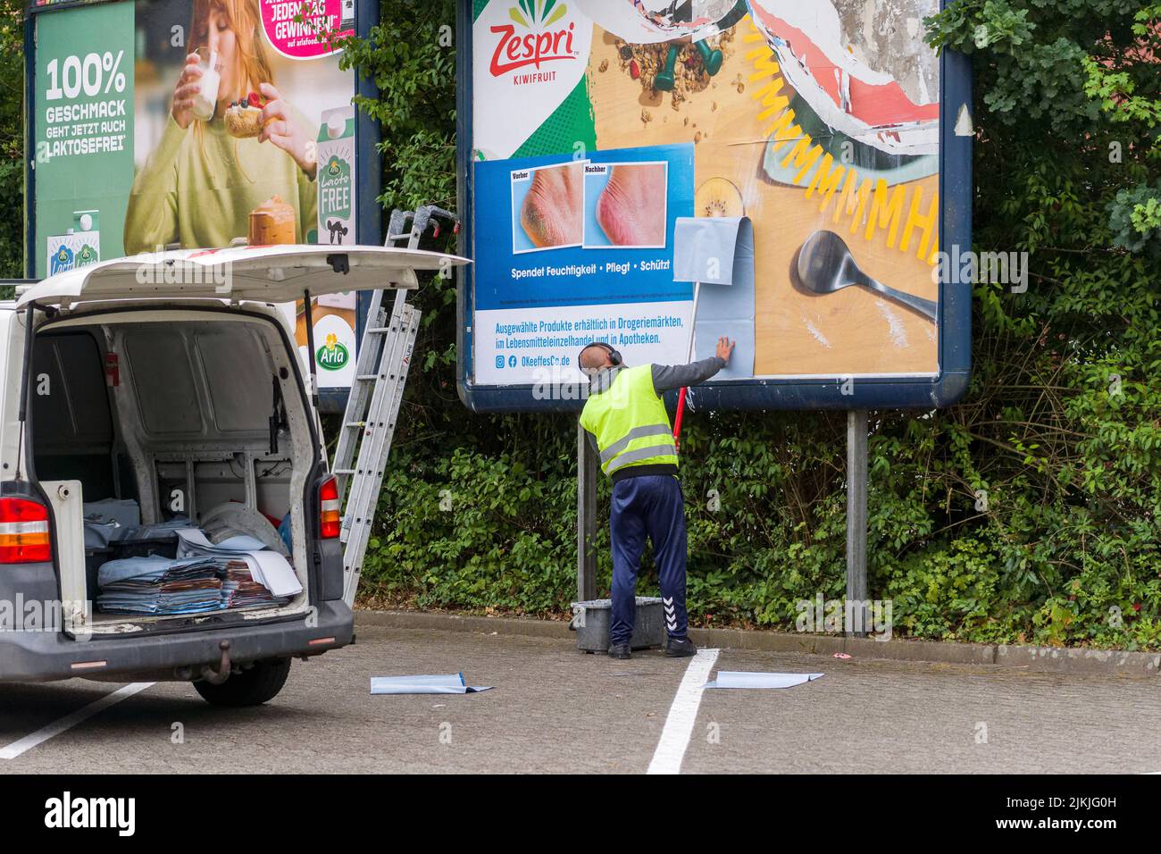 Poster sticker paste over a billboard new Stock Photo - Alamy