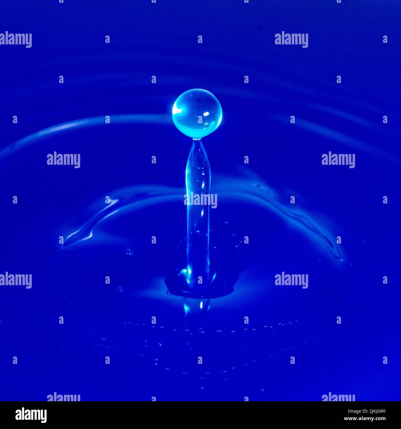 A vertical shot of one drop of water with blue backlight - perfect for ...