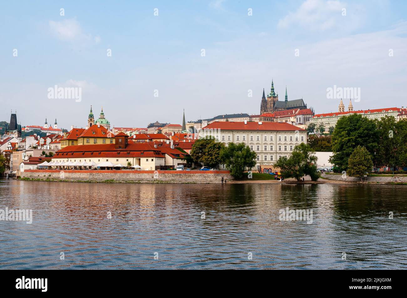 The beautiful view of Vltava river with buildings and Prague Castle in ...