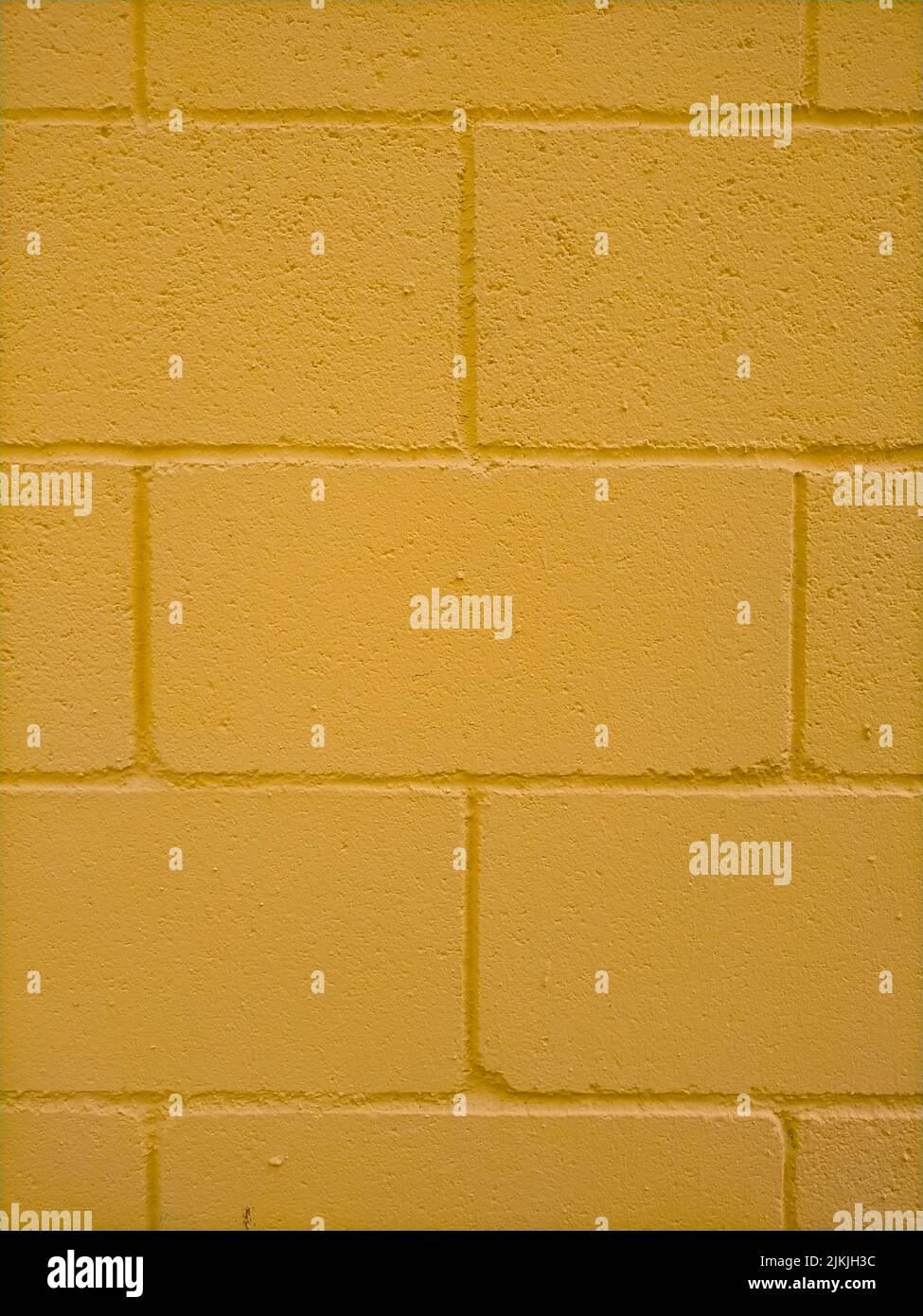 A yellow painted brick wall texture Stock Photo - Alamy