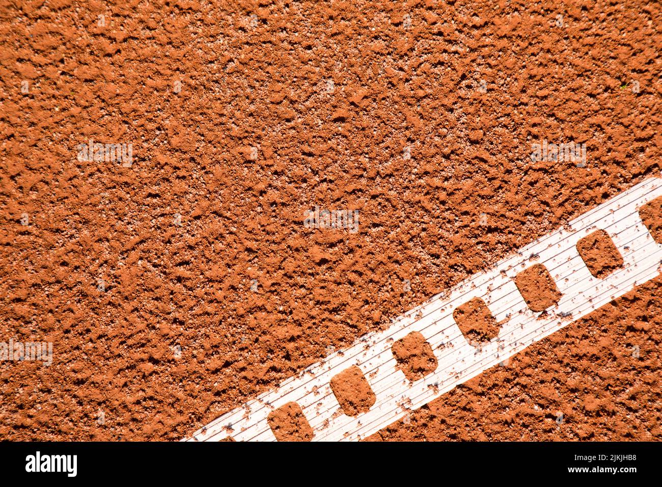 A orange painted stone wall texture with white painted tape with copy ...