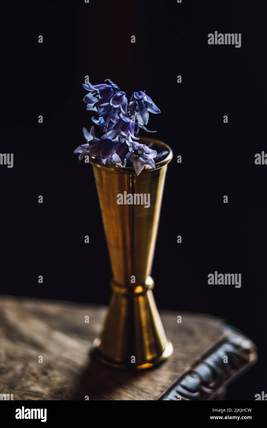 brass gold cocktail jigger with flowers blue bells Stock Photo - Alamy