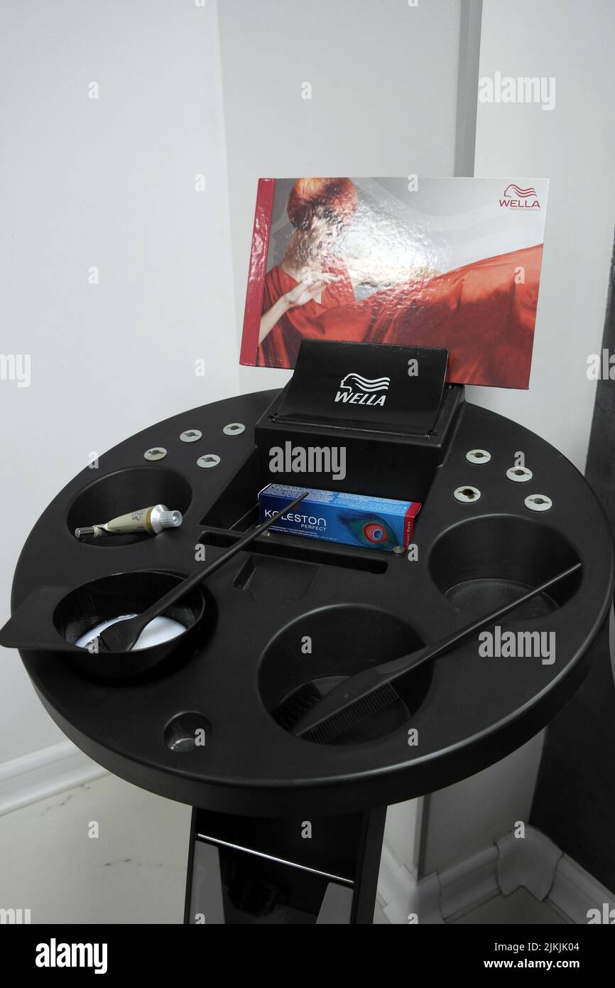 A vertical closeup of the round table with the hair-dying equipment in ...