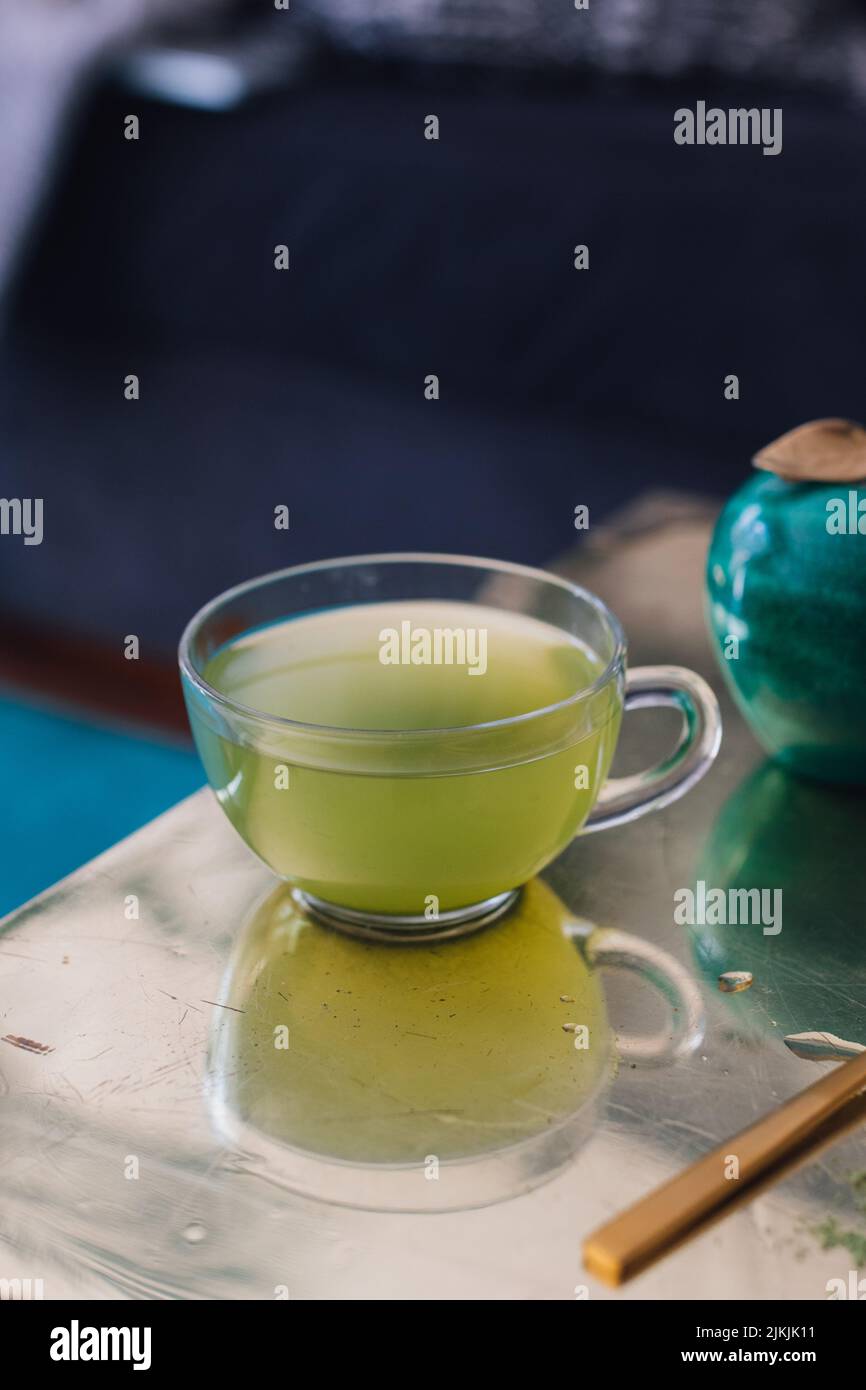 matcha green tea in clear teacup on gold table Stock Photo - Alamy