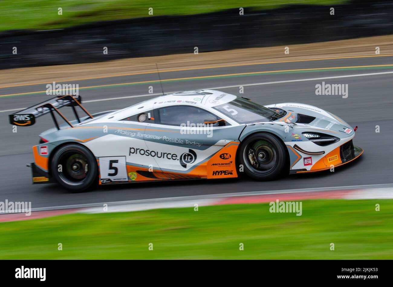 A long exposure shot of a McLaren 720S orange car during the race in ...