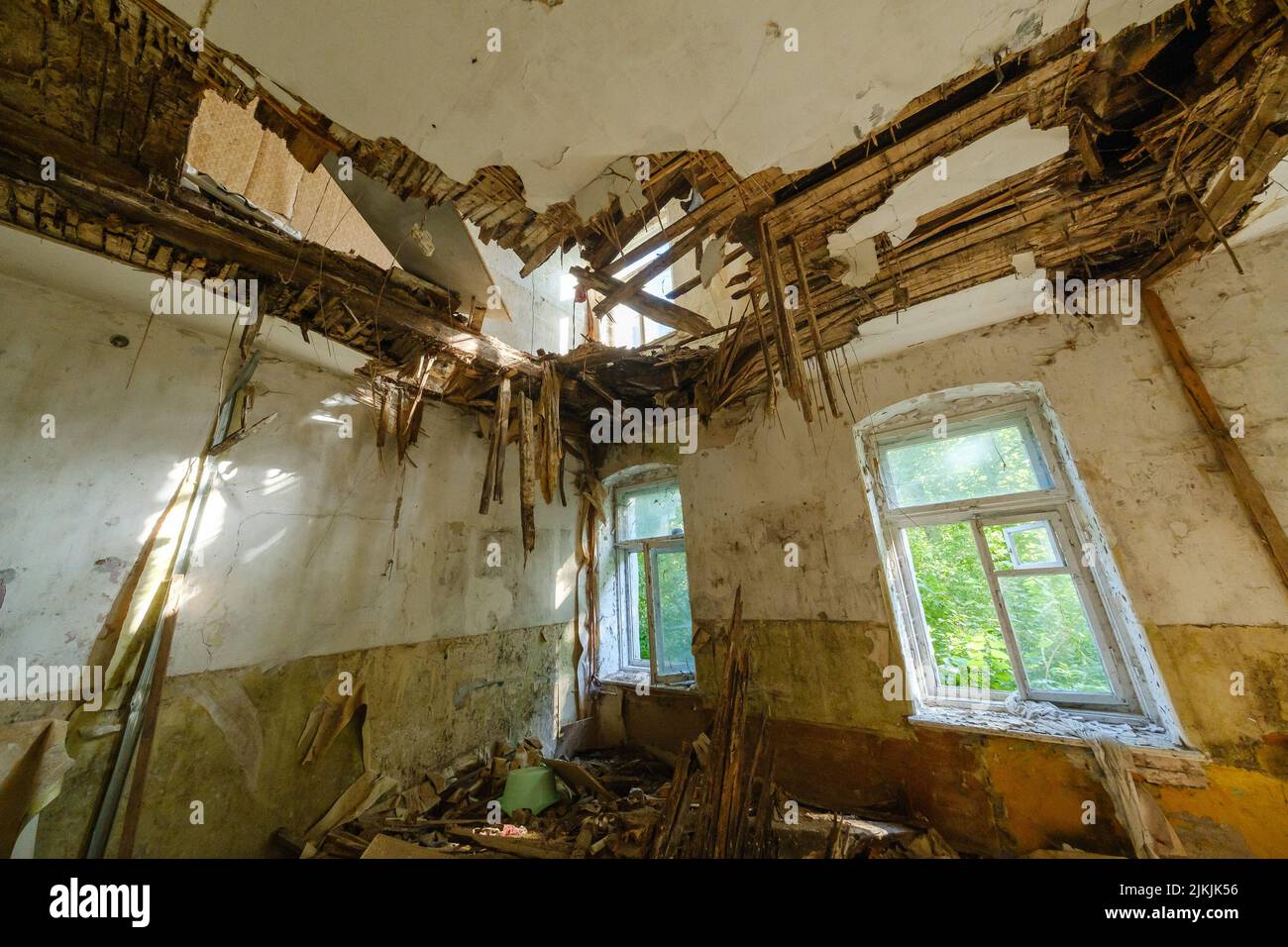 Interior of sunlit room with broken ceiling Stock Photo - Alamy