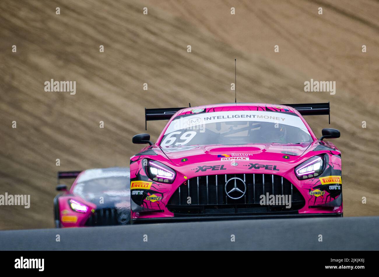 A low angle shot of a Mercedes-AMG GT3 pink car during the race in the ...