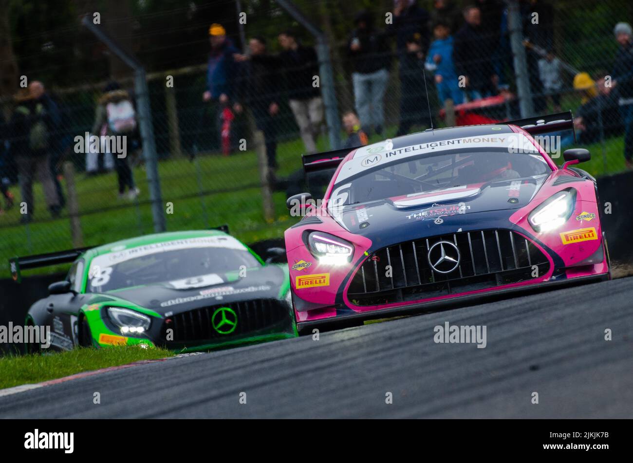 A low angle shot of a Mercedes-AMG GT3 pink and green car during the ...