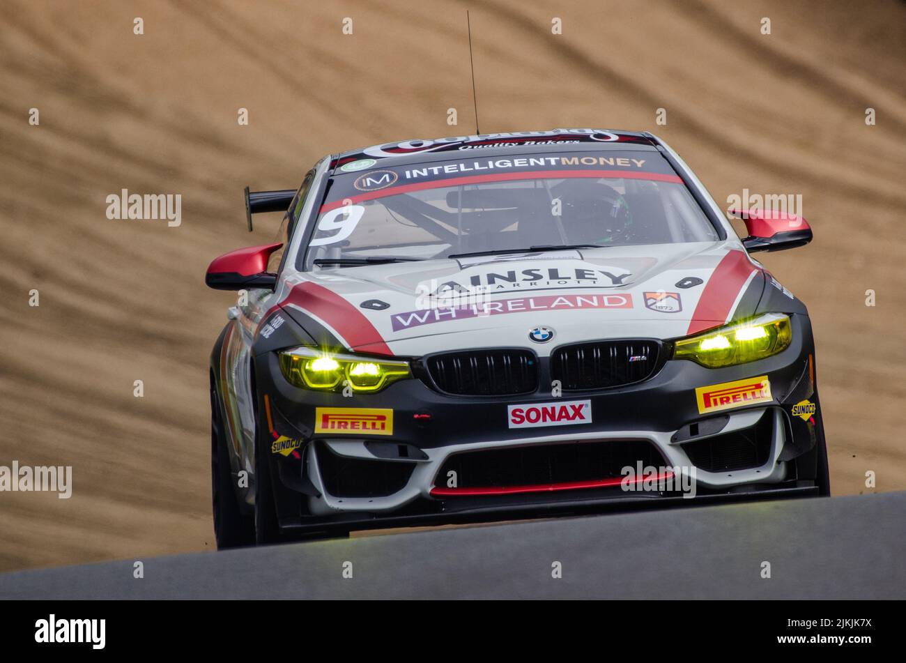 A low angle shot of a BMW M4 DTM black car during the race in the ...