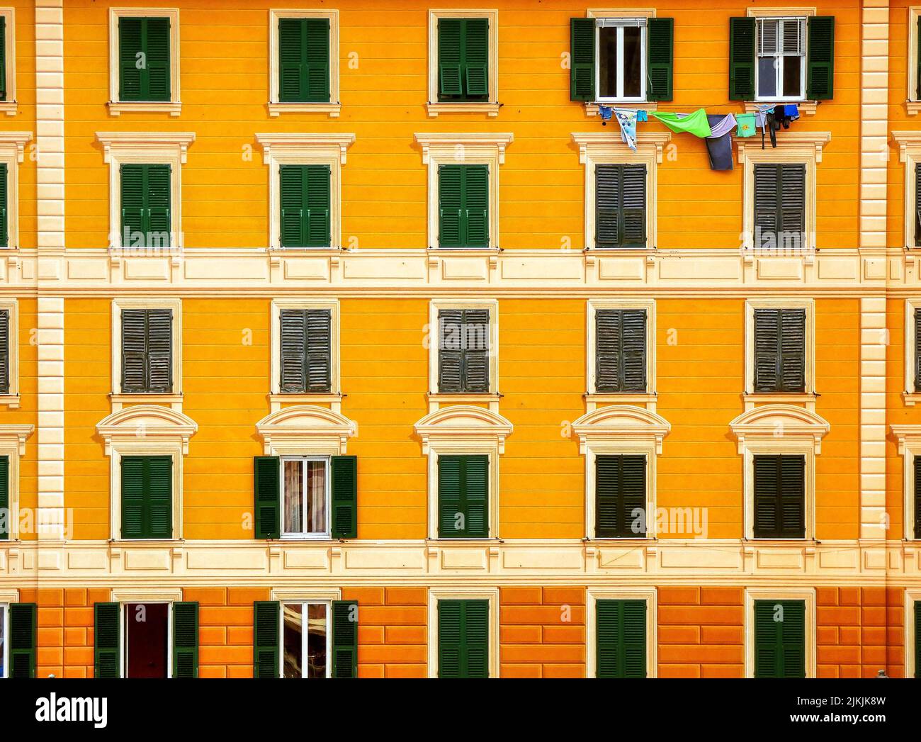 The exterior of a bright orange residential building Stock Photo - Alamy