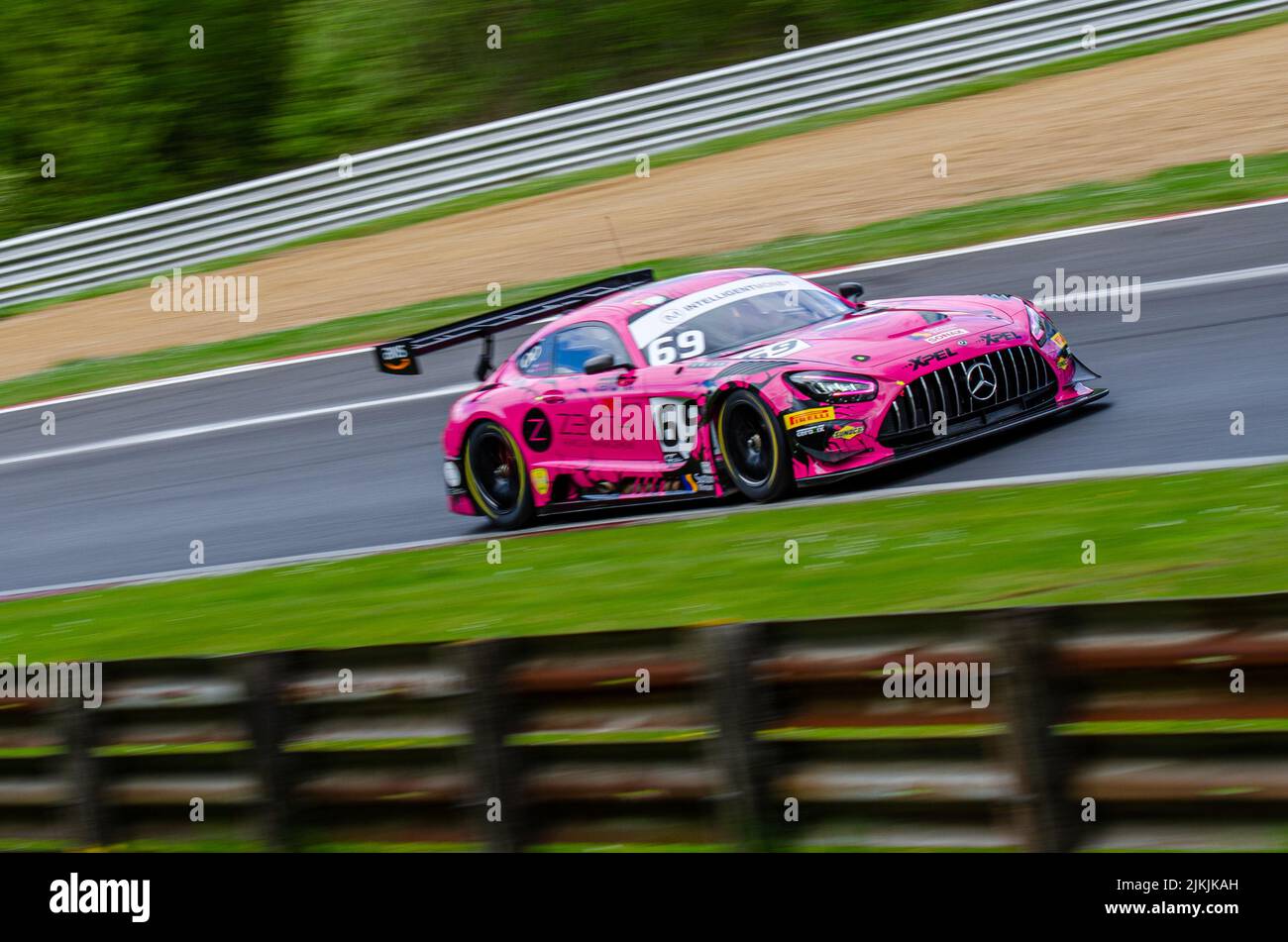 A long exposure shot of a Mercedes-AMG GT3 pink car during the race in ...