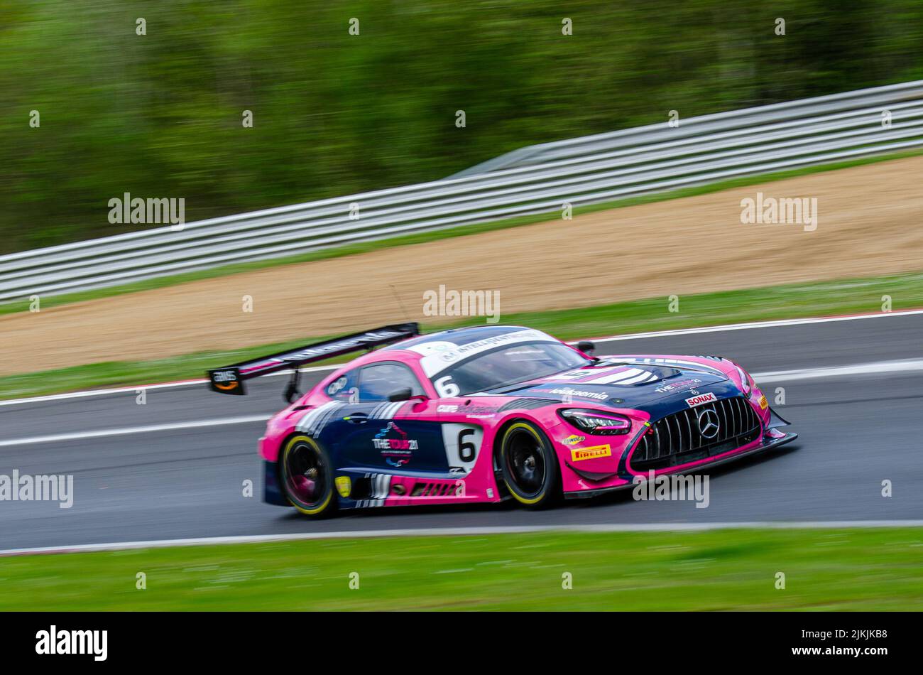 A long exposure shot of a Mercedes-AMG GT3 pink car during the race in ...