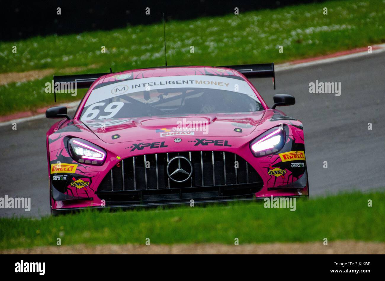 A low angle shot of a Mercedes-AMG GT3 pink car during the race in the ...