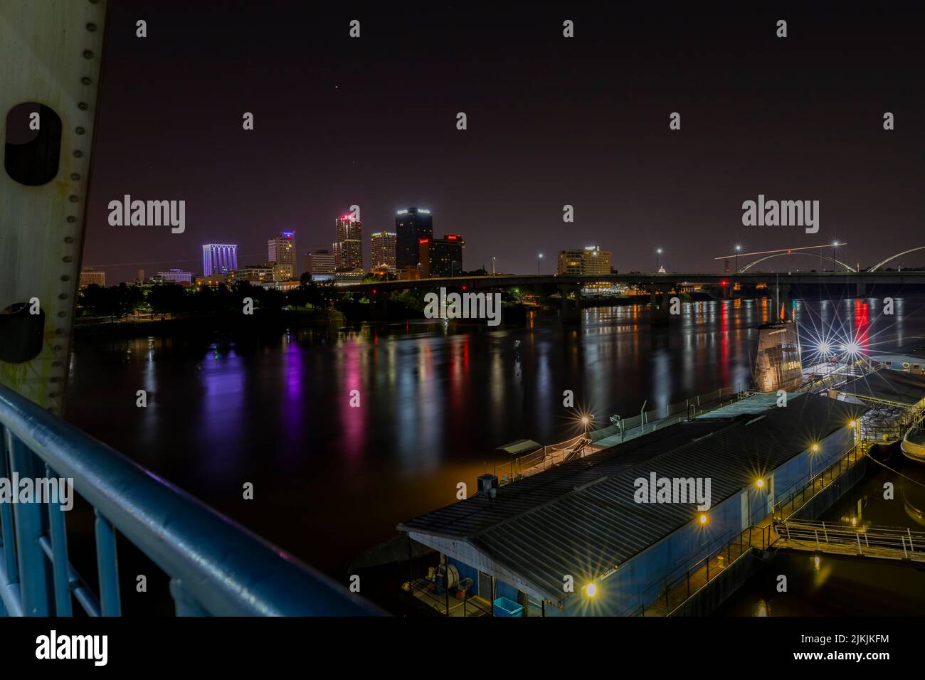 A beautiful night view of a cityscape with a lake and modern buildings ...