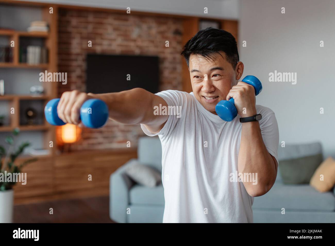 Fitness and sport concept. Active mature man exercising with two ...