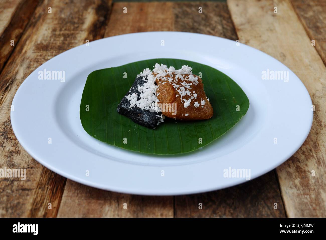 Getuk or food from cassava and coconut on a plate and banana leaf with ...