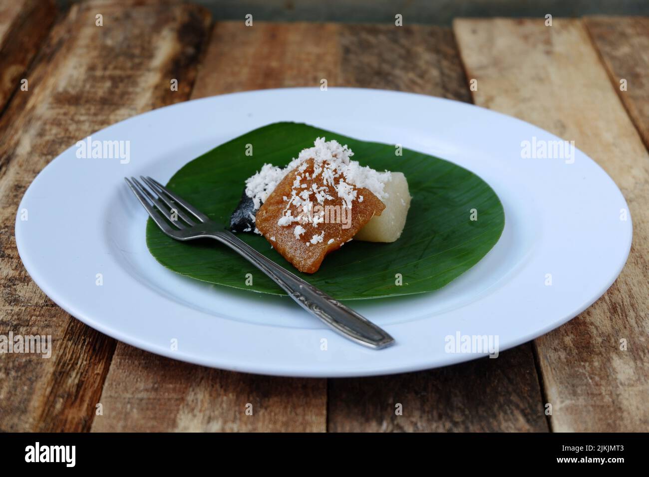 Getuk or food from cassava and coconut on a plate and banana leaf with ...