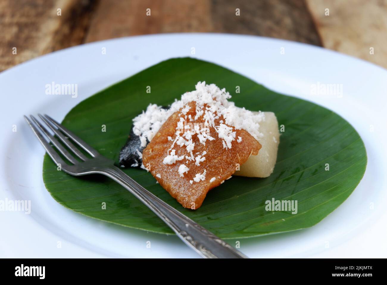 Getuk or food from cassava and coconut on a plate and banana leaf with ...