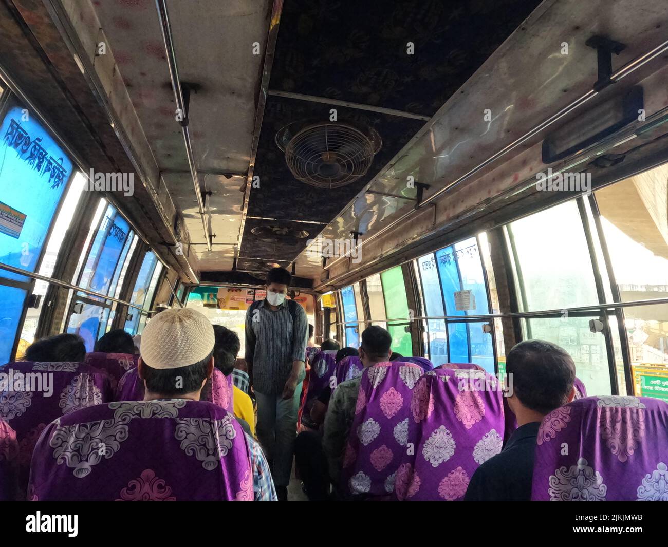 A beautiful shot of people sitting inside public bus transportation in Dhaka City People ...