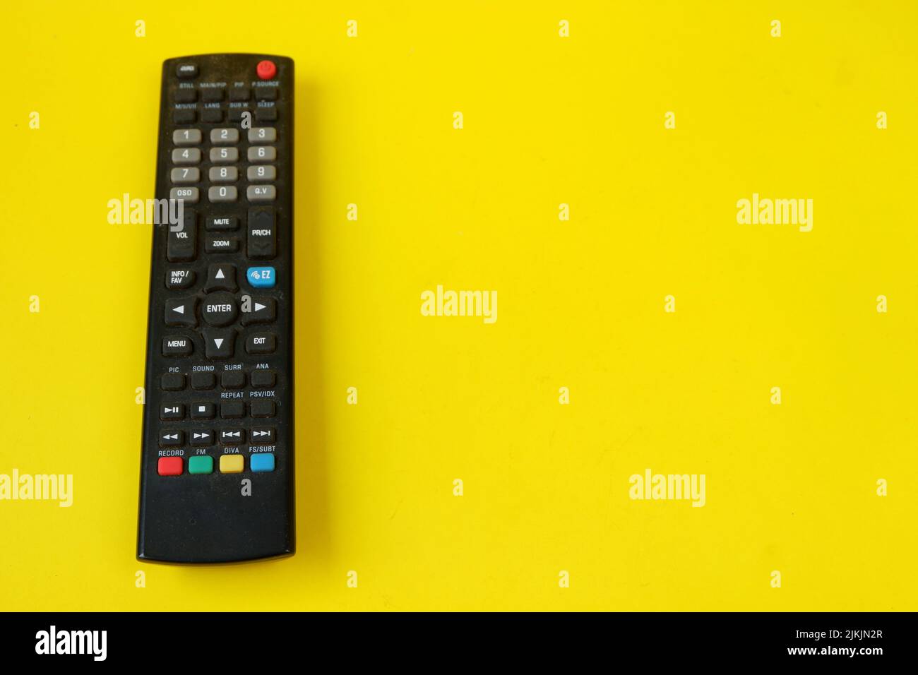 tv remote isolated on yellow background Stock Photo - Alamy