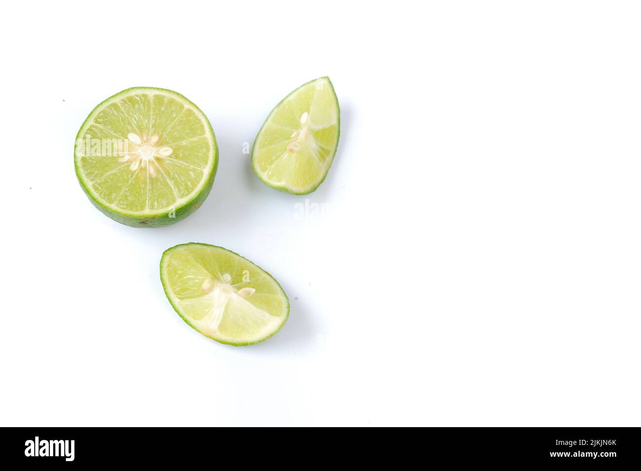 Lime with slices isolated on a white background Stock Photo - Alamy