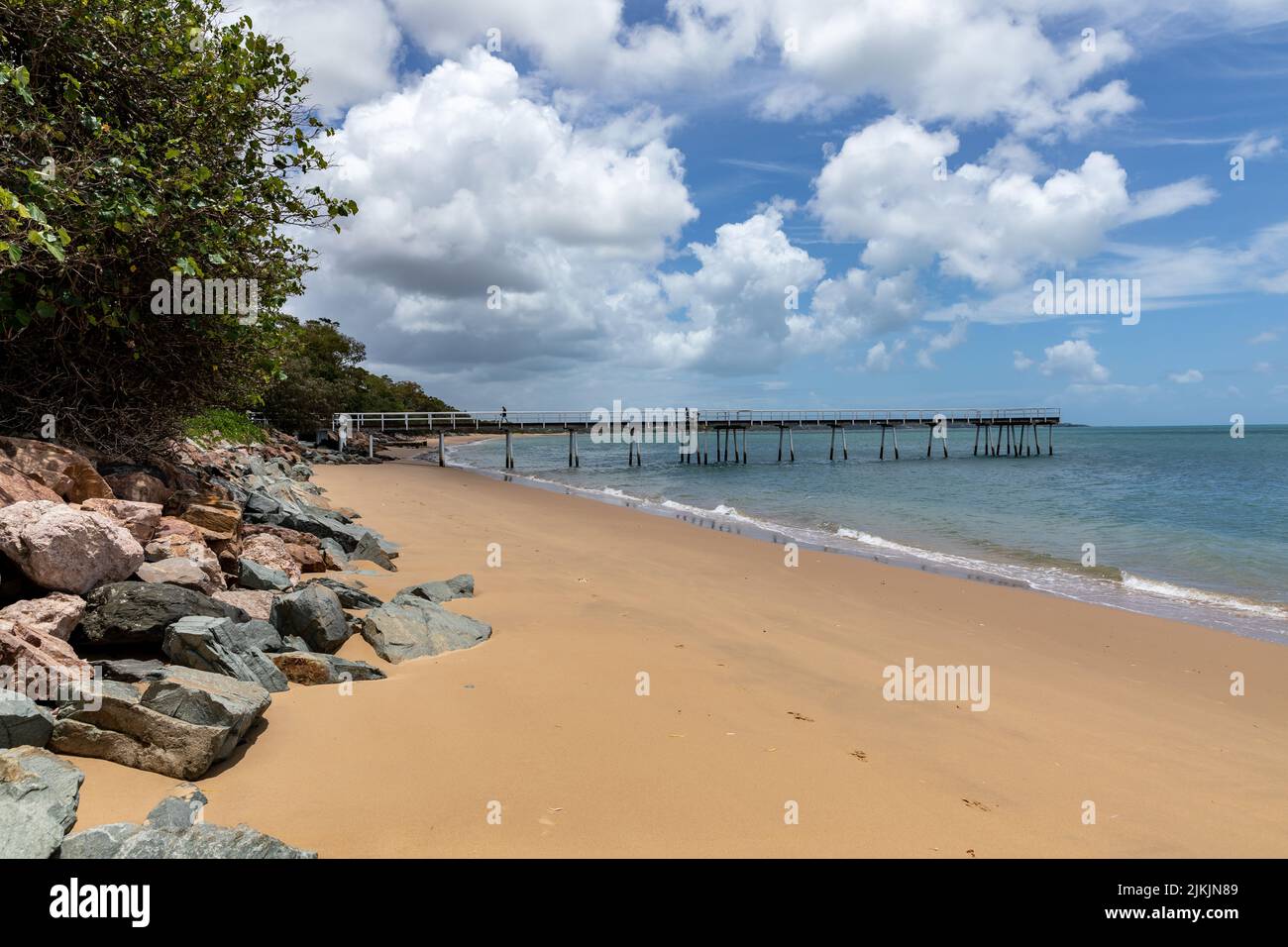 The rocks with trees and bridge in Scarness beach at Hervey bay Stock ...
