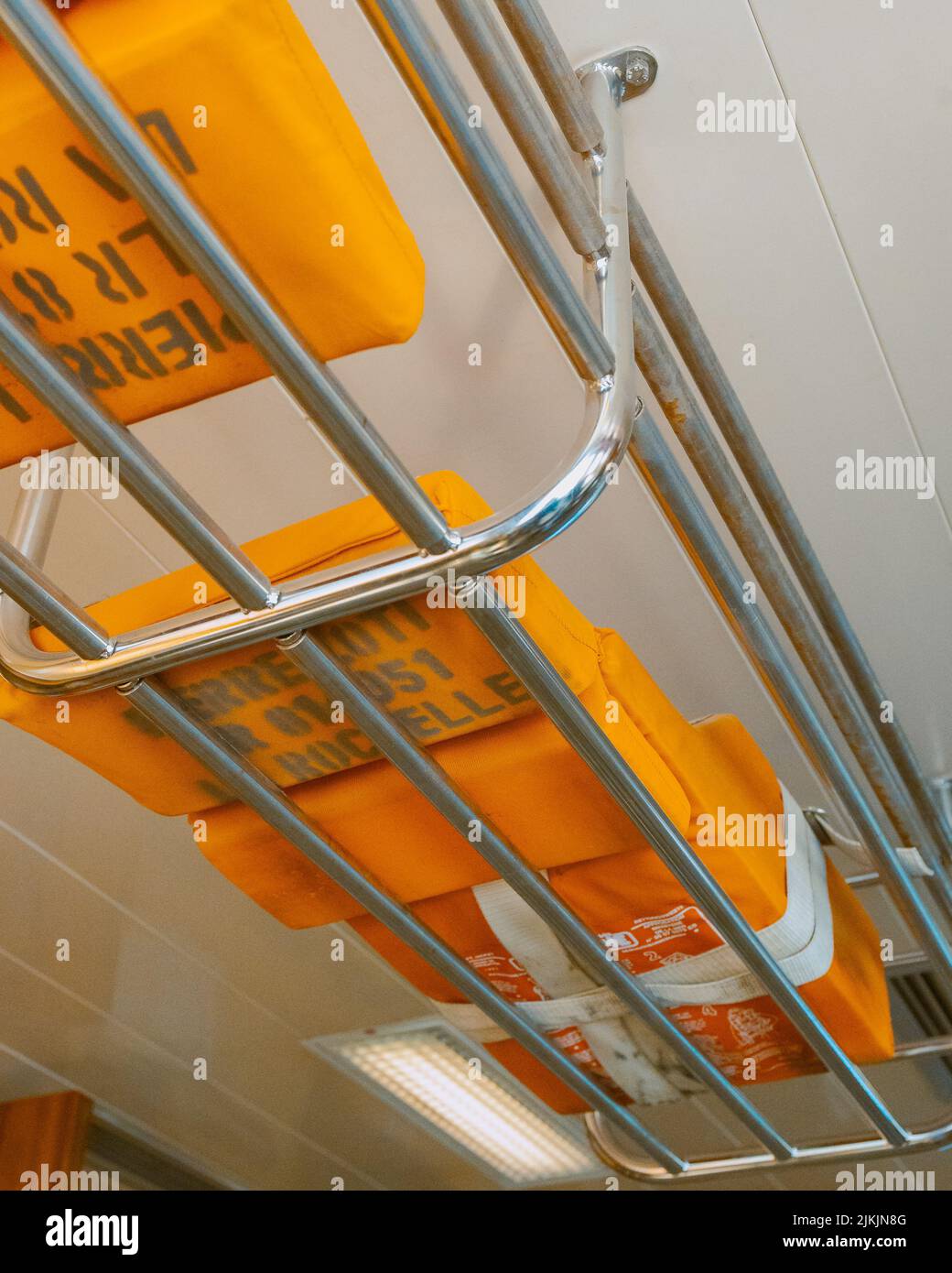 A vertical shot of some objects placed on a metallic shelf in the boat ...