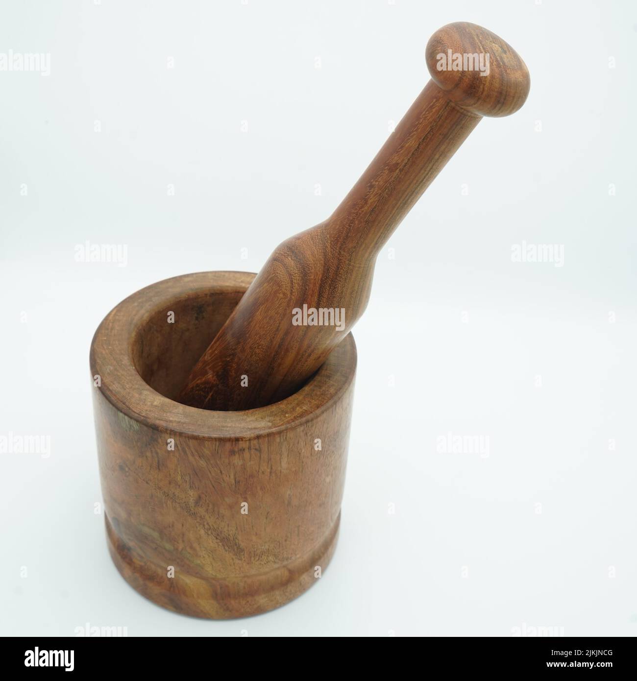 A wooden mortar and pestle on a white background Stock Photo - Alamy