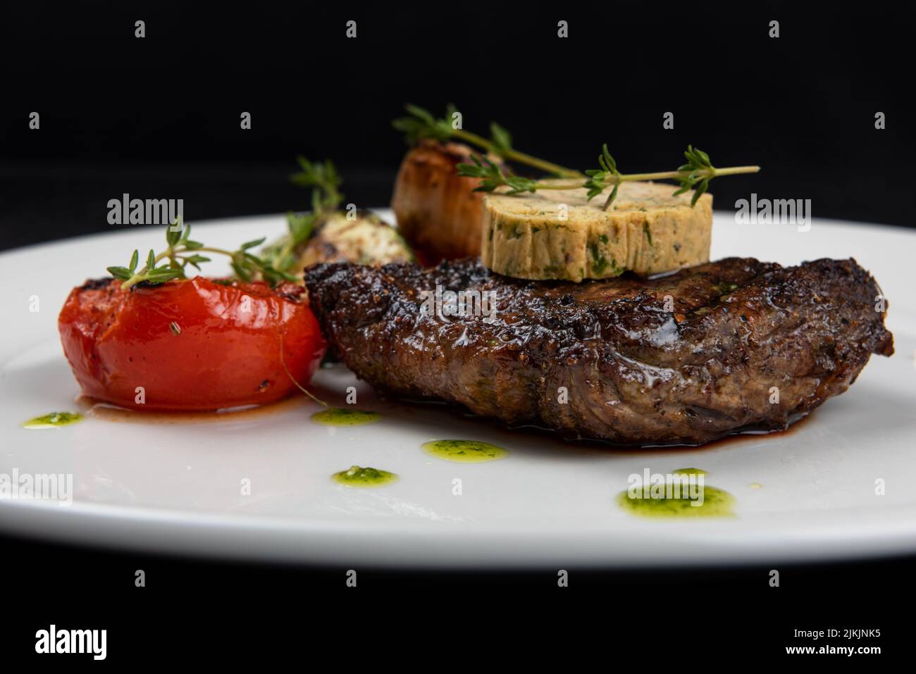 Grilled black angus strip loin steak with vegetables Stock Photo - Alamy