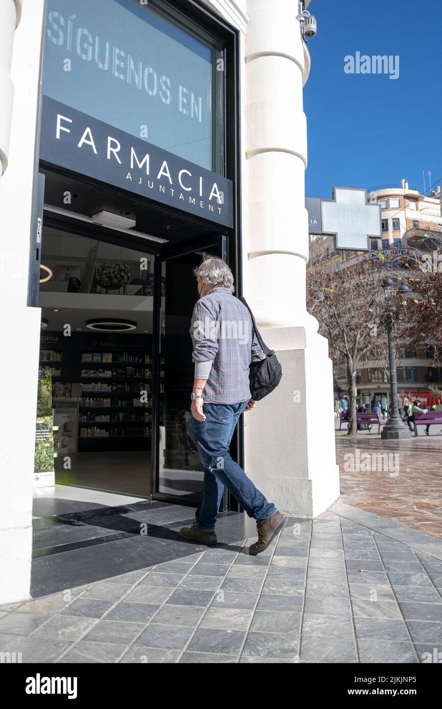 A senior male entering pharmacy in Valencia, Spain Stock Photo - Alamy