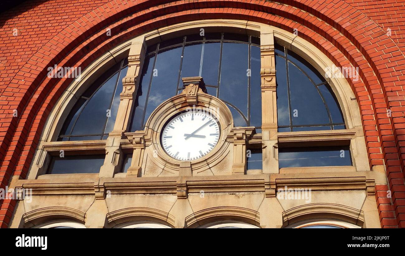 A close-up shot of a building with a clock on a facade Stock Photo - Alamy