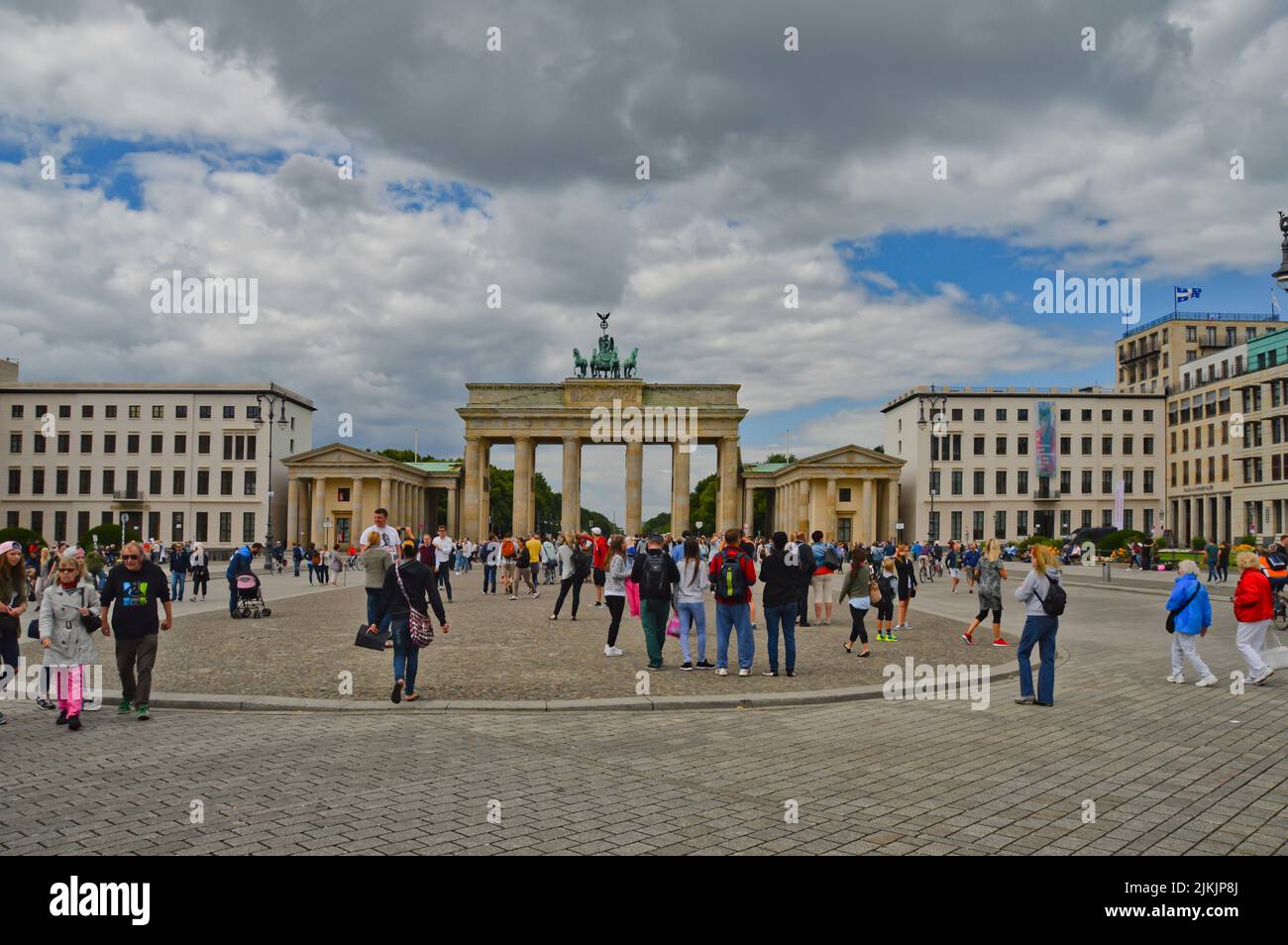 A beautiful shot of tourists strolling in front of the Brandenburg Gate ...