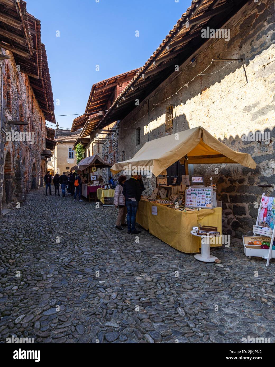 A vertical shot of people and the typical medieval village Ricetto di ...