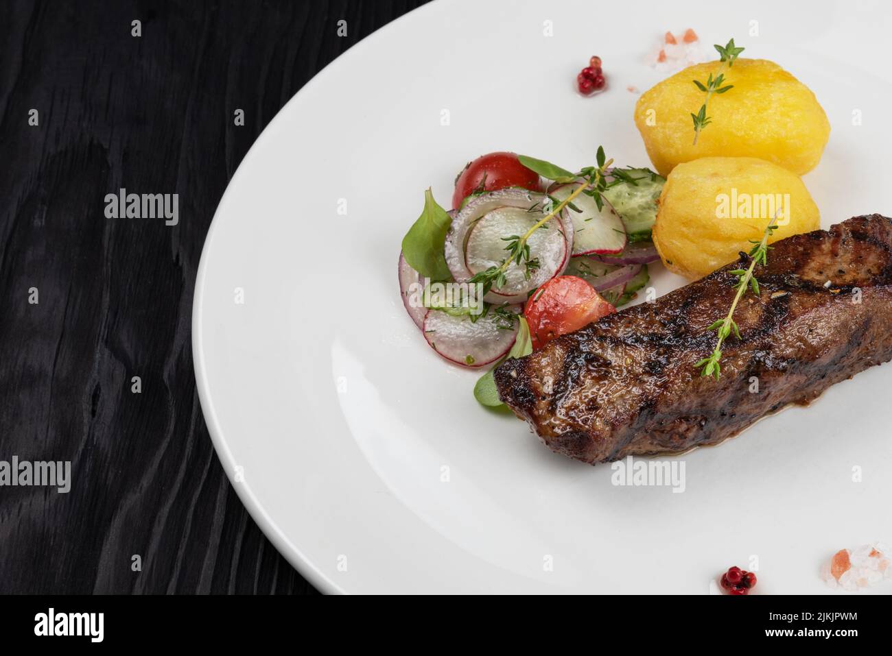 Grilled black angus strip loin steak with vegetables Stock Photo - Alamy