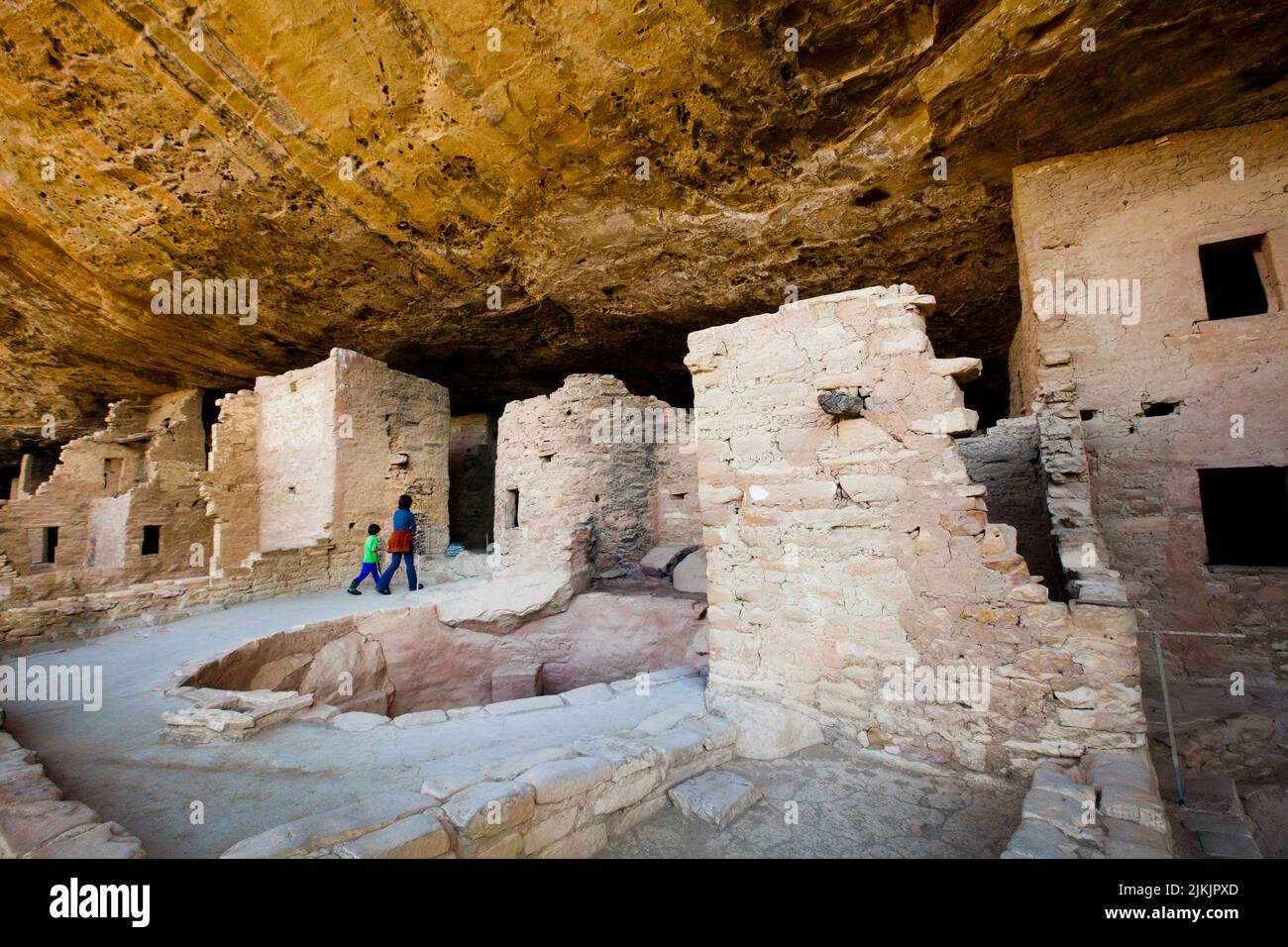 Mother and son visit Spruce Tree House ruins located in Mesa Verde ...