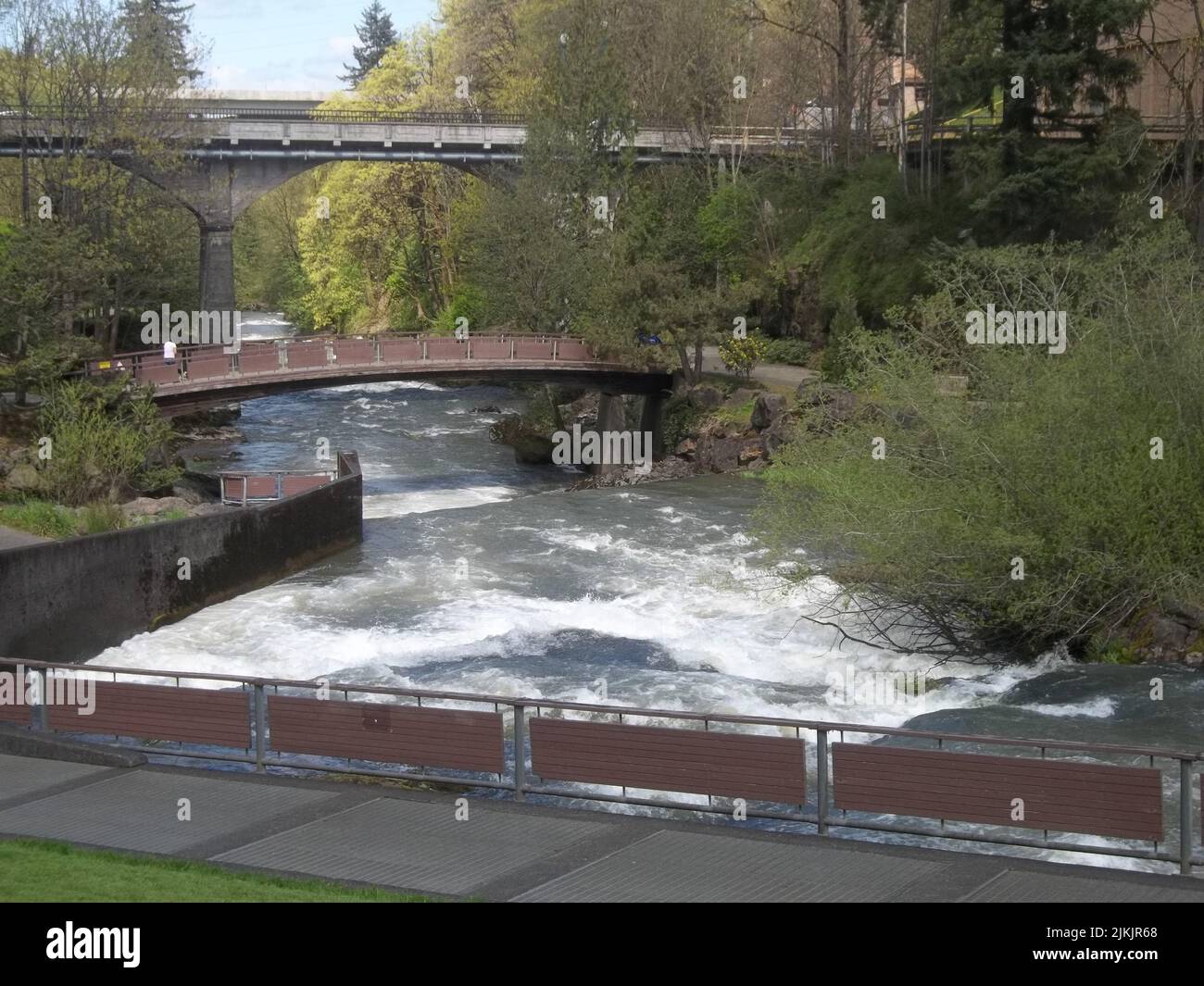 A different sized bridges over the fast flow river in the daytime Stock ...