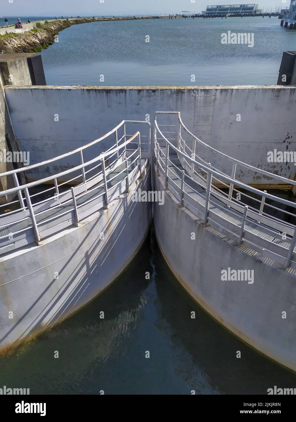 A vertical shot of two arch-shaped bridges in the background of the ...