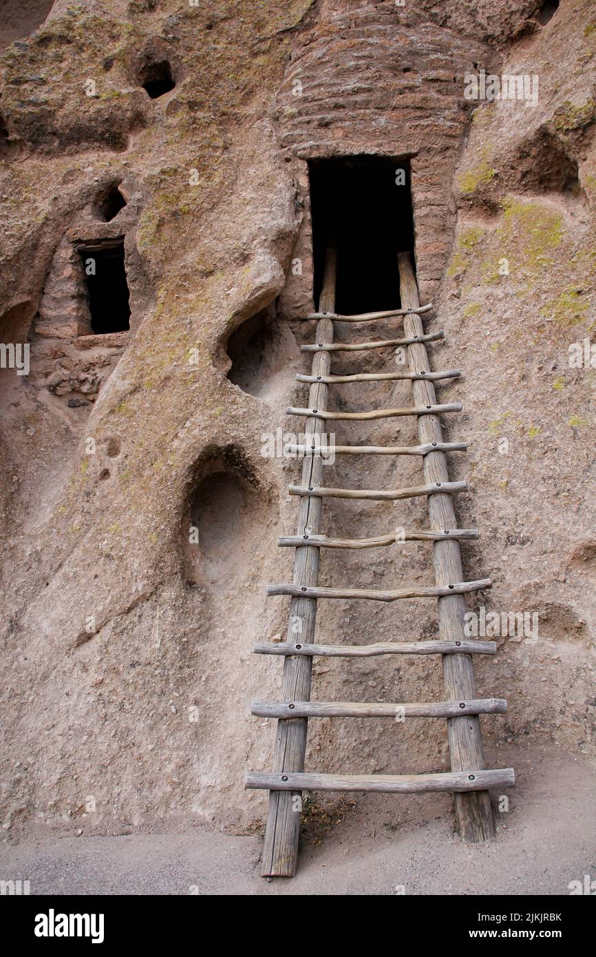 A vertical shot of a ladder leading to a cliff dwelling at the ...